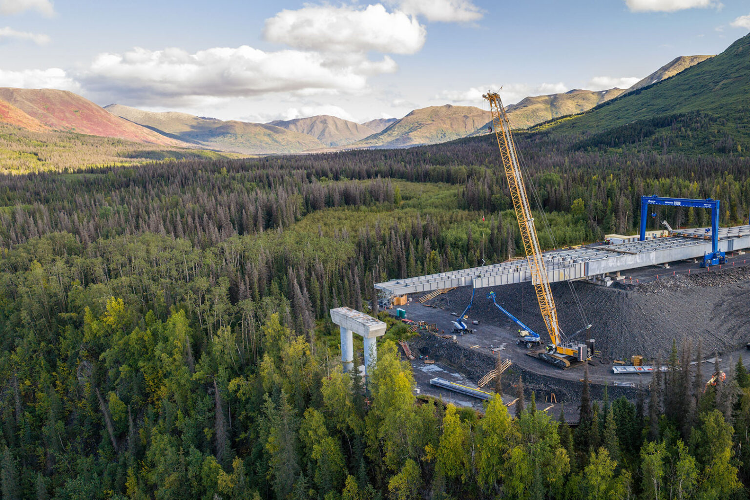 Two Liebherr cranes bring the banks of Juneau Creek Bridge in Alaska ...